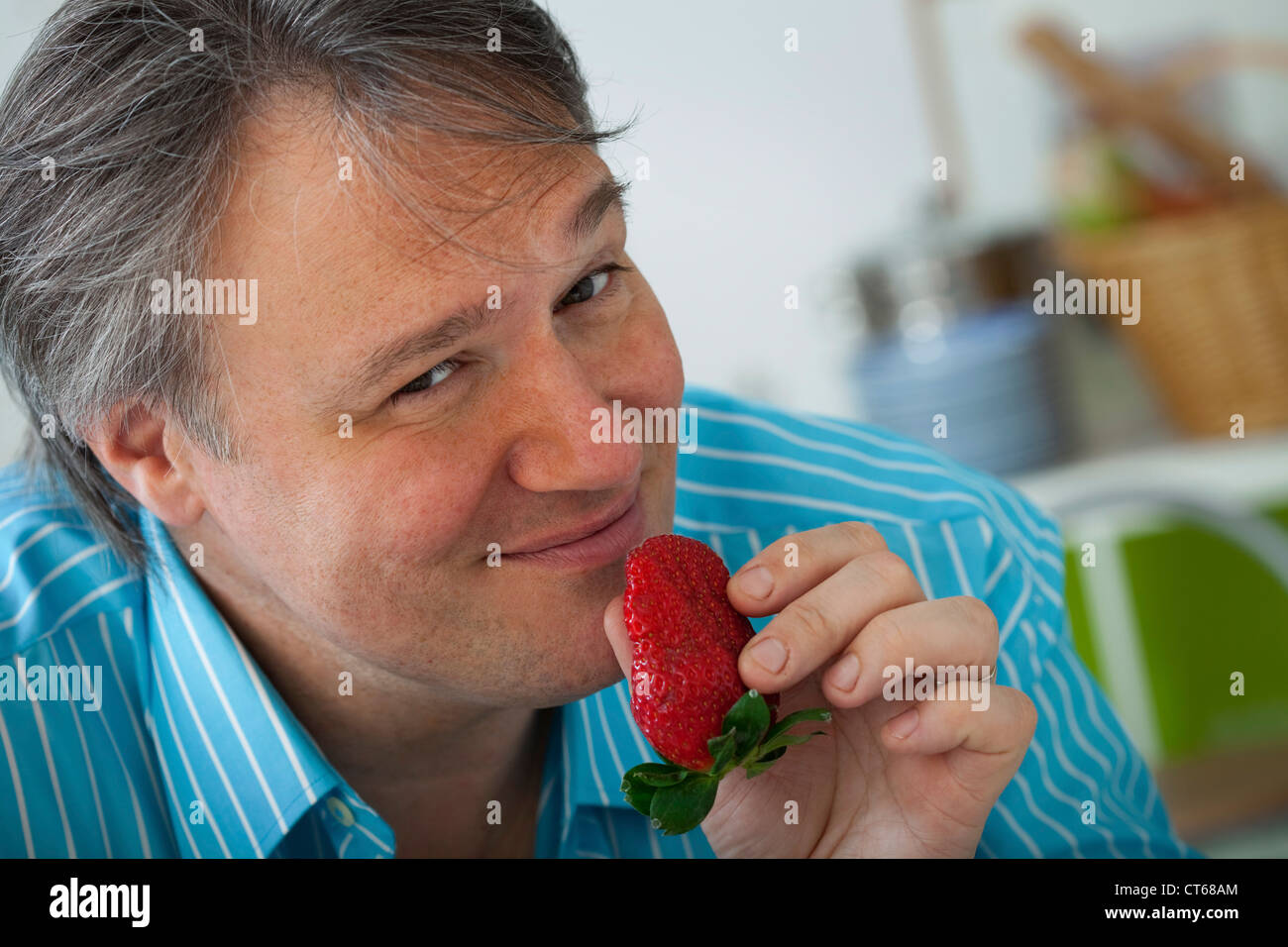 MAN EATING FRUIT Stock Photo - Alamy
