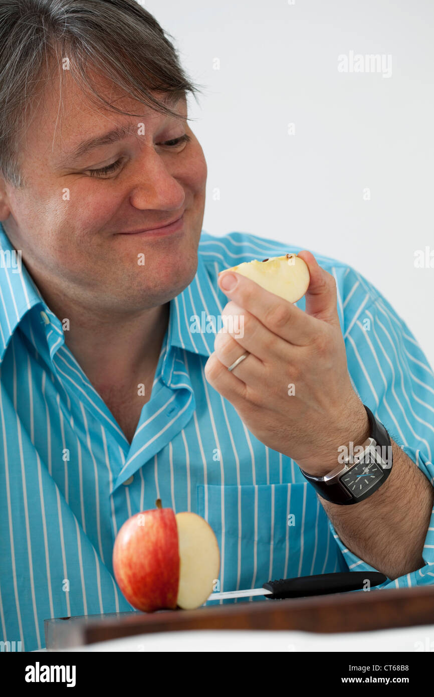 MAN EATING FRUIT Stock Photo - Alamy