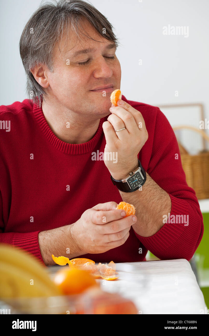 MAN EATING FRUIT Stock Photo - Alamy