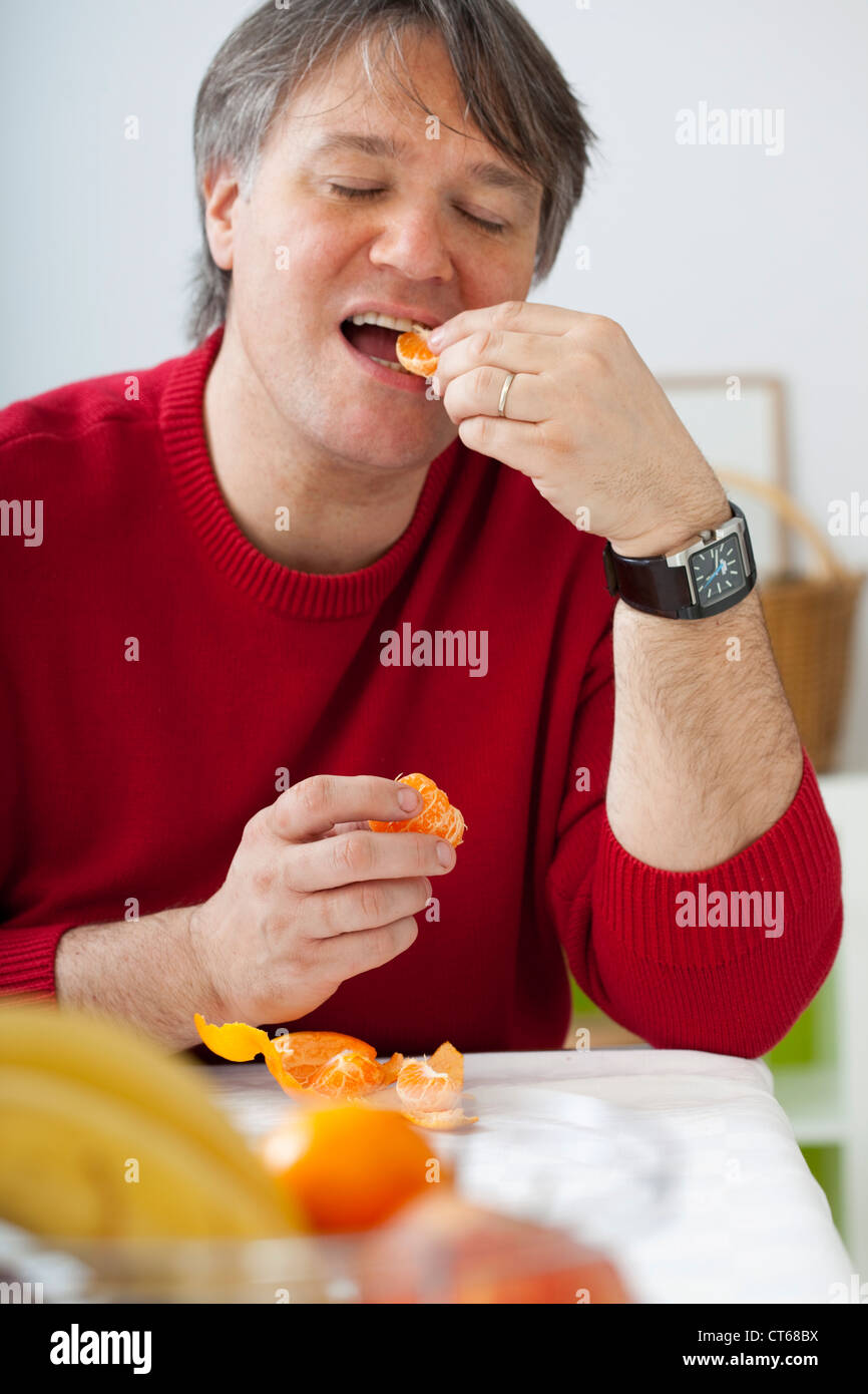 MAN EATING FRUIT Stock Photo - Alamy