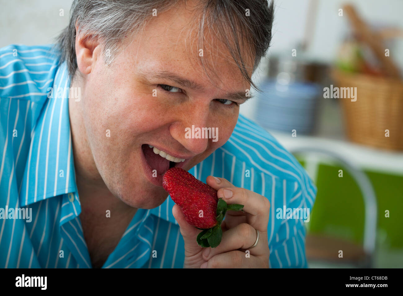 MAN EATING FRUIT Stock Photo - Alamy