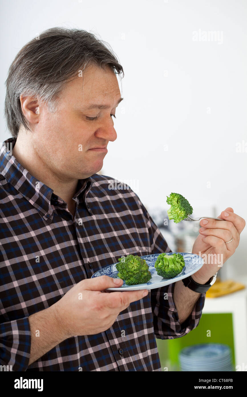 MAN EATING VEGETABLE Stock Photo - Alamy