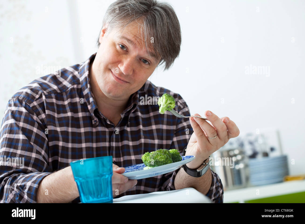 MAN EATING VEGETABLE Stock Photo - Alamy
