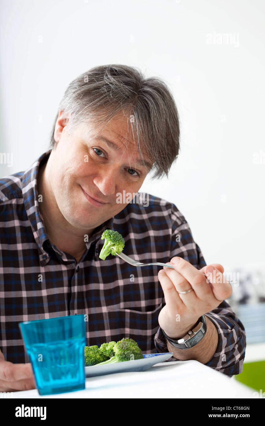 MAN EATING VEGETABLE Stock Photo - Alamy