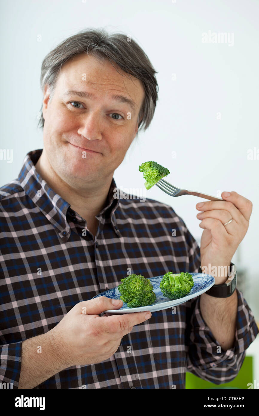 MAN EATING VEGETABLE Stock Photo - Alamy