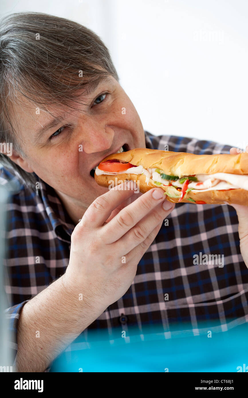 Old man eating sandwich hi-res stock photography and images - Alamy