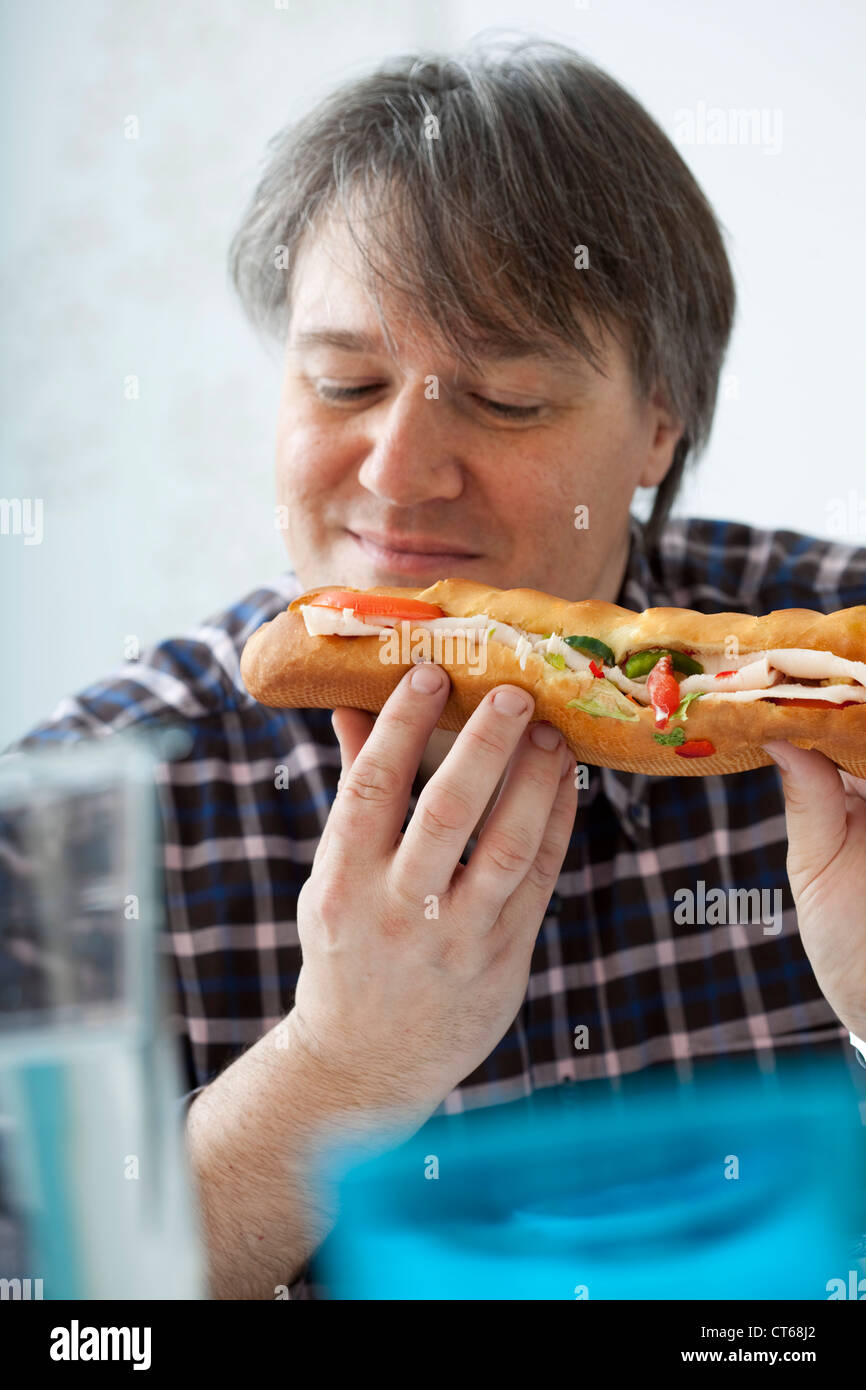 Old man eating sandwich hi-res stock photography and images - Alamy