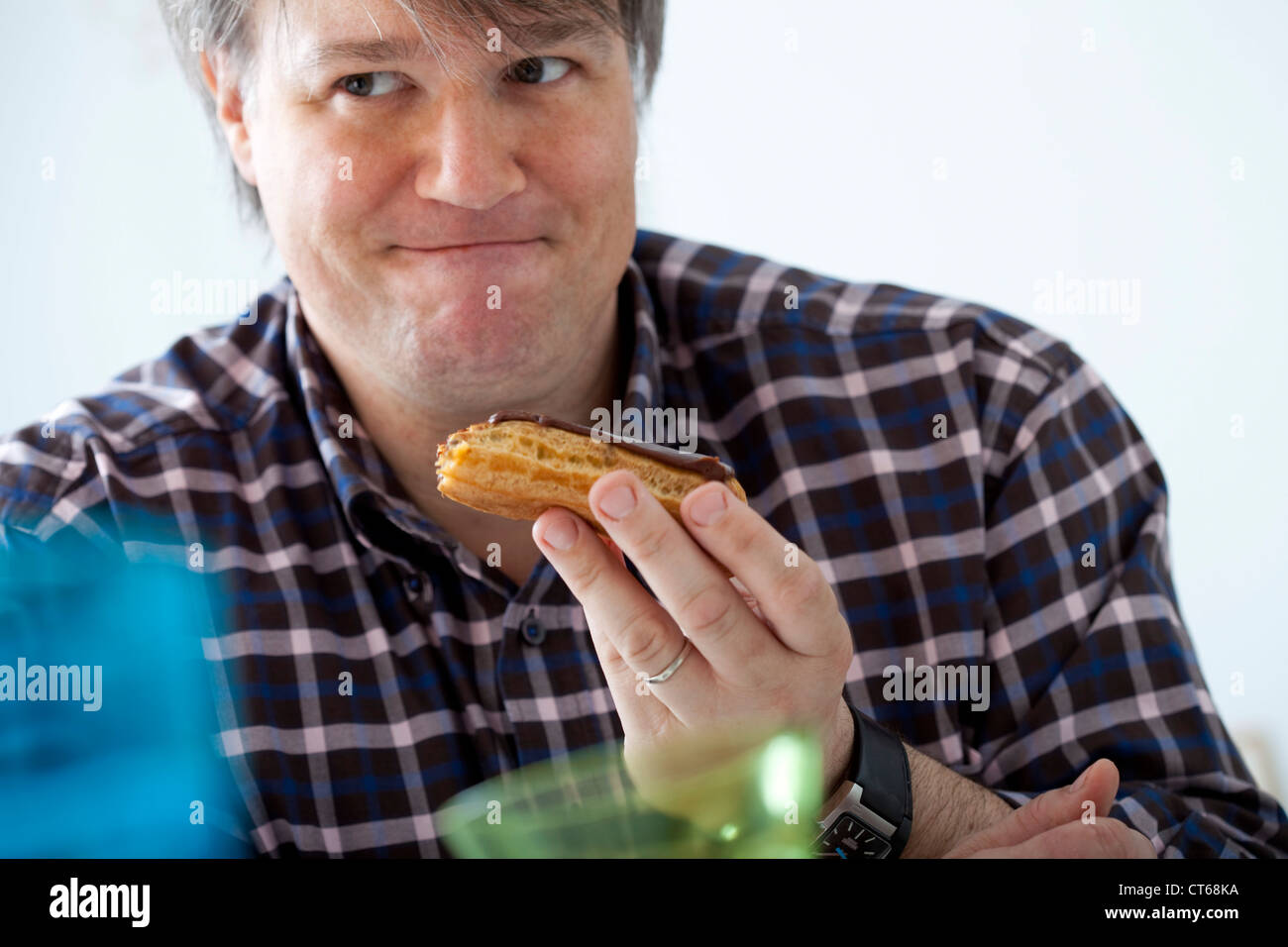MAN EATING SWEETS Stock Photo - Alamy
