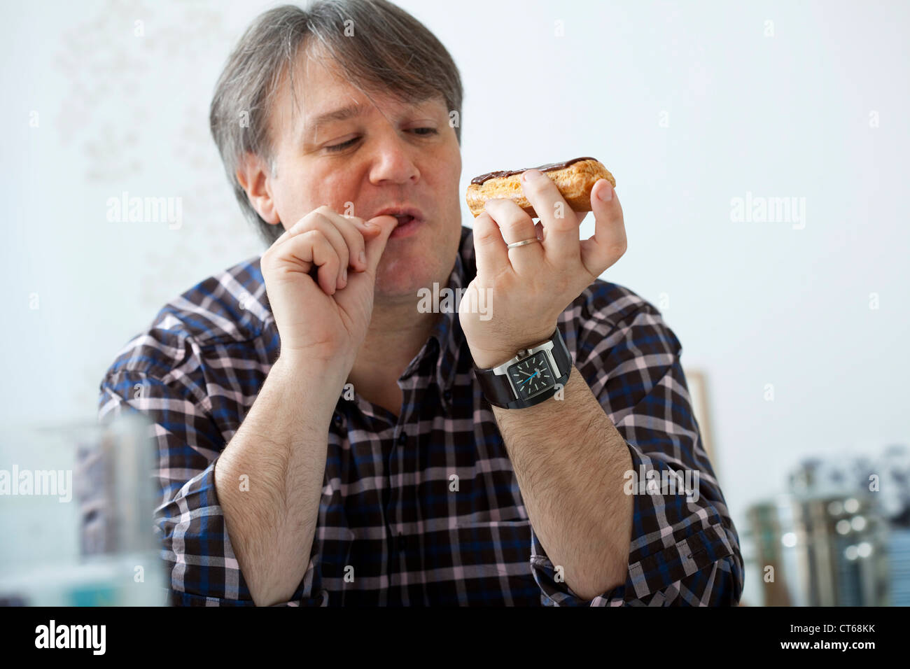 MAN EATING SWEETS Stock Photo - Alamy