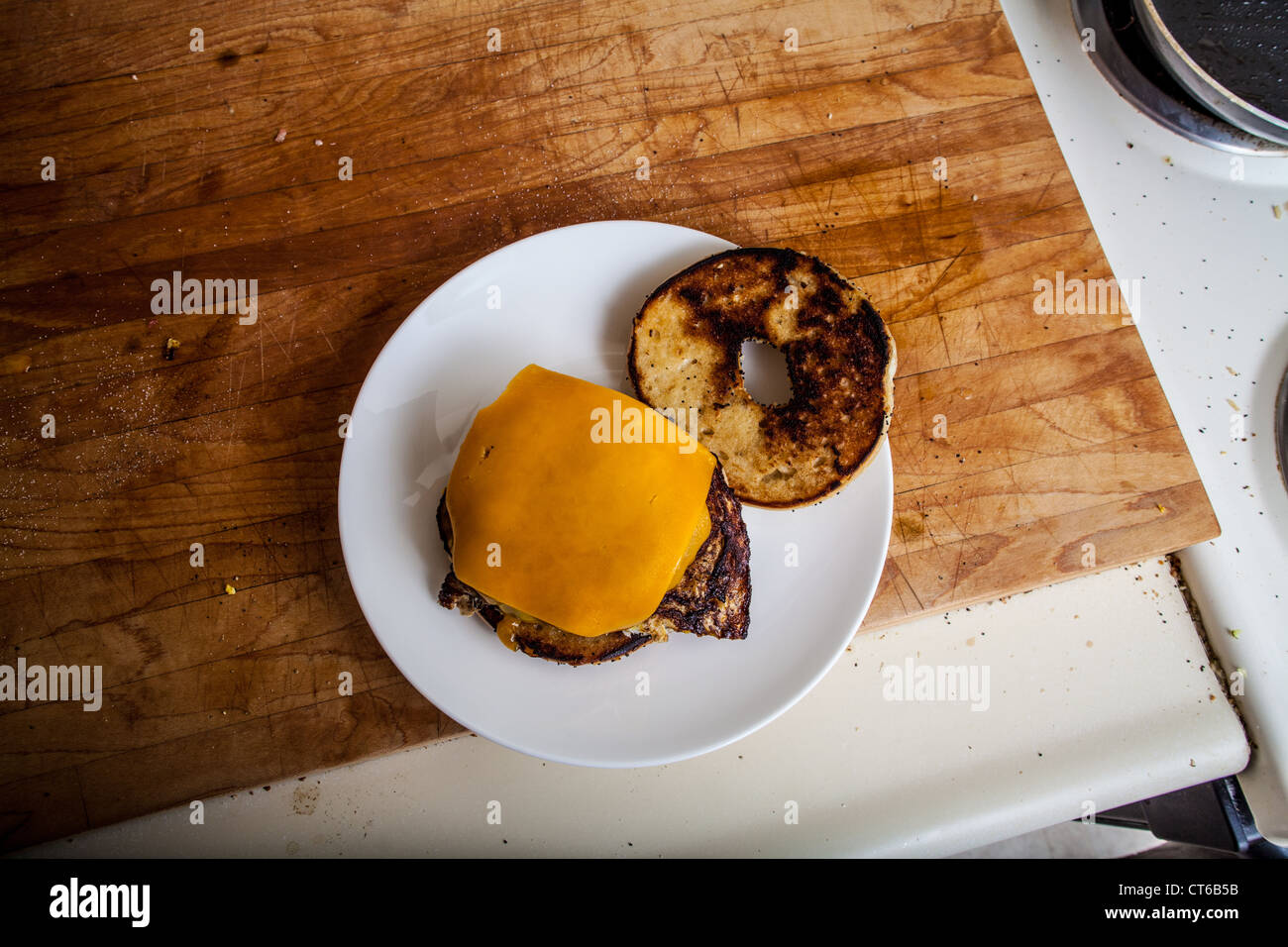 A sausage egg cheese bagel breakfast sandwich slightly over cooked ...