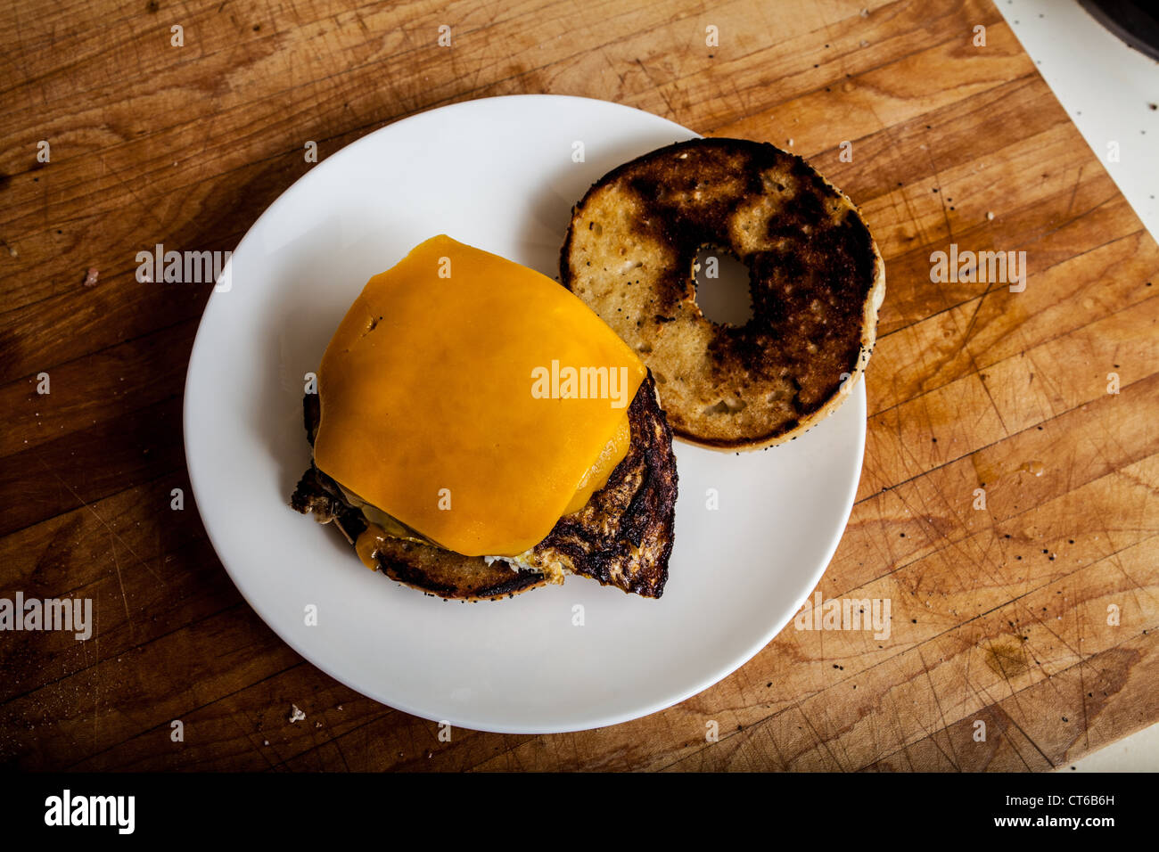 A sausage egg cheese bagel breakfast sandwich slightly over cooked ...