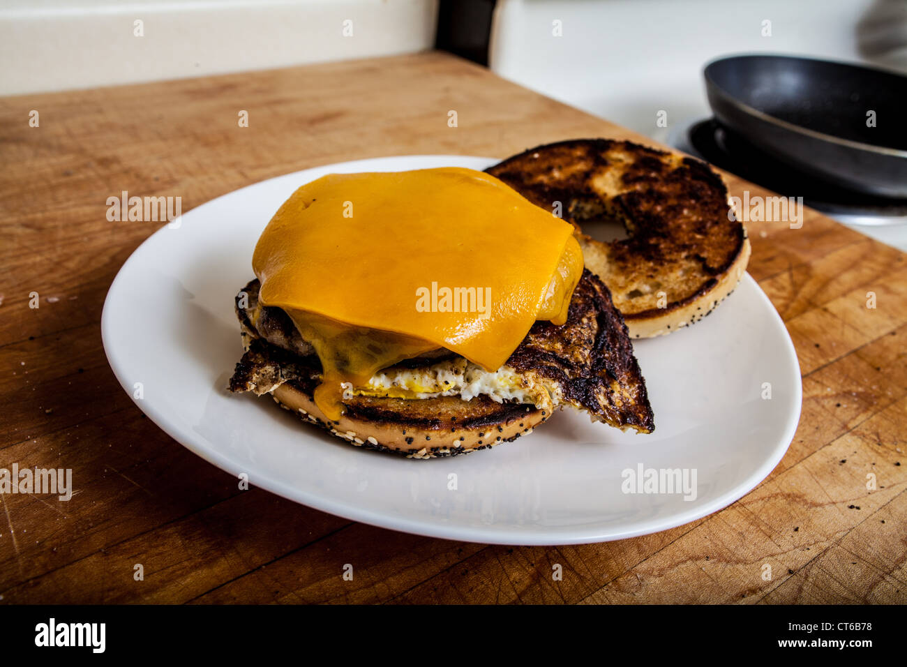 A sausage egg cheese bagel breakfast sandwich slightly over cooked ...