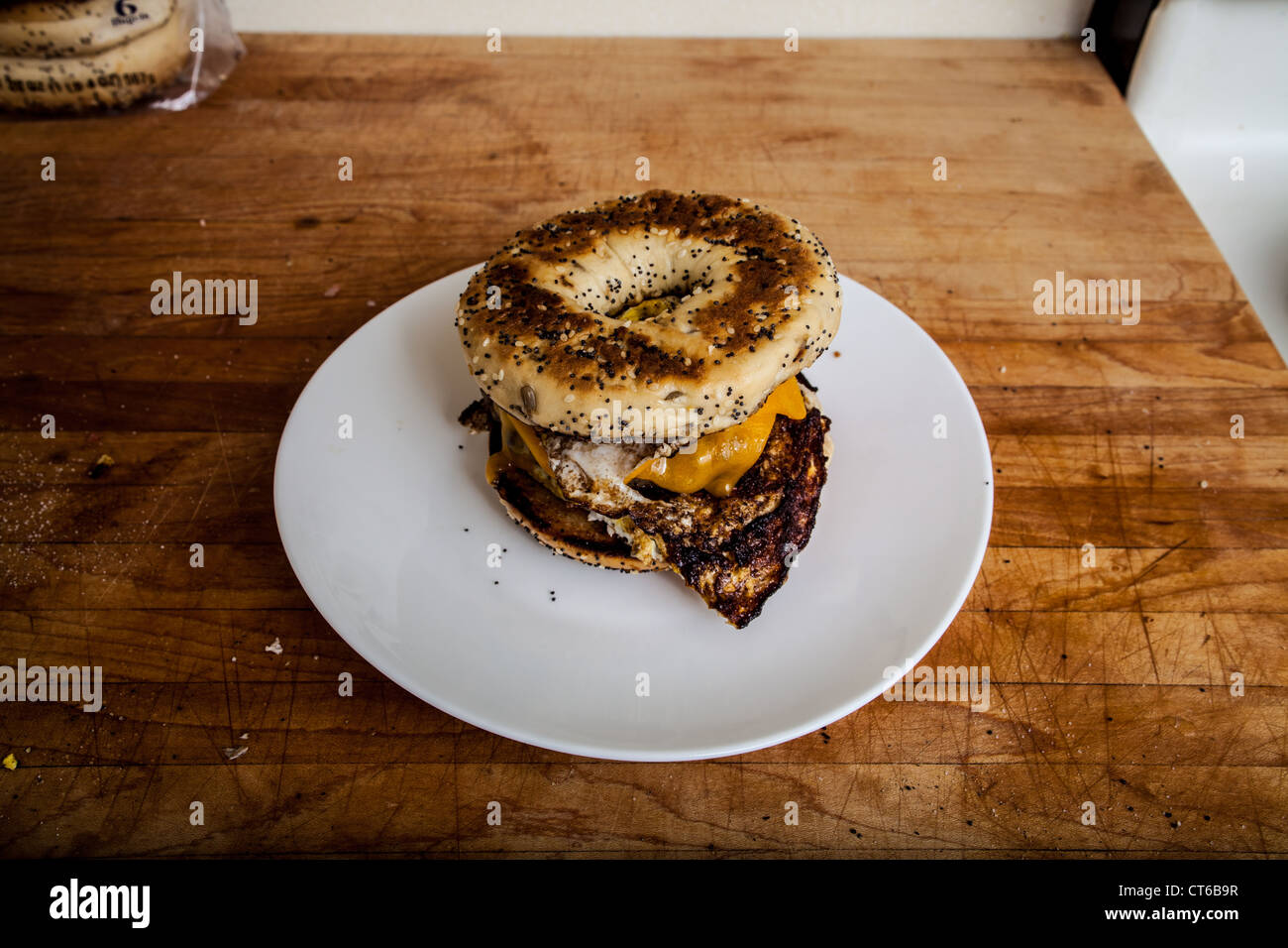 A sausage egg cheese bagel breakfast sandwich slightly over cooked ...