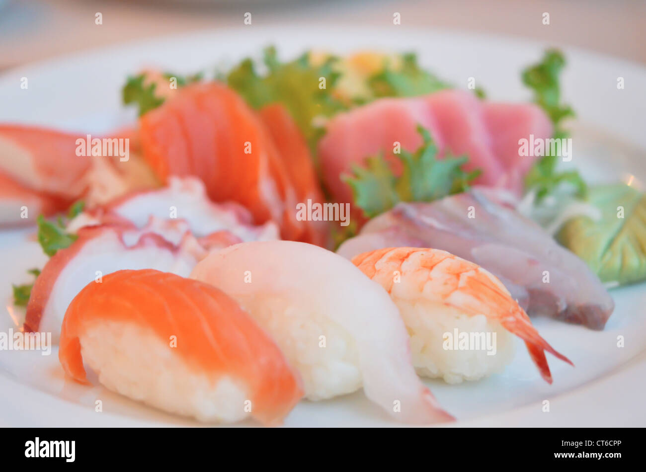 Mixed sushi and sashimi served on white plate Stock Photo - Alamy