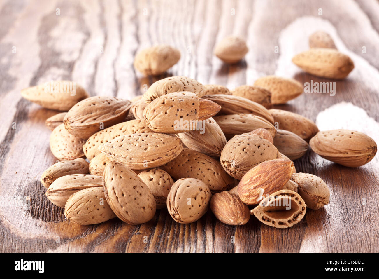Nuts almonds on a wooden table Stock Photo - Alamy