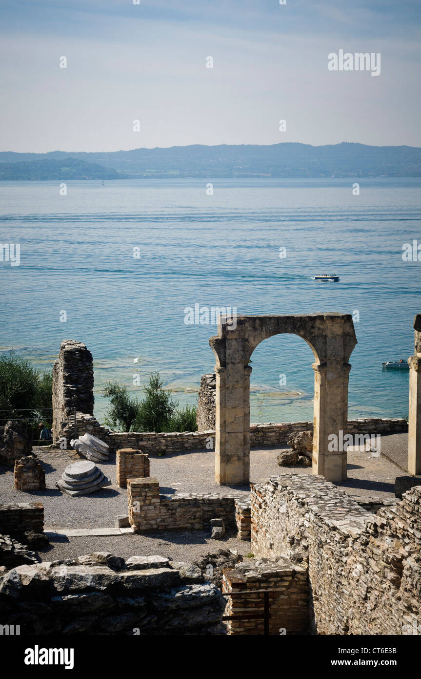 View of Garda Lake and Roman ruins known as "Catullo Caves" in Sirmione ...