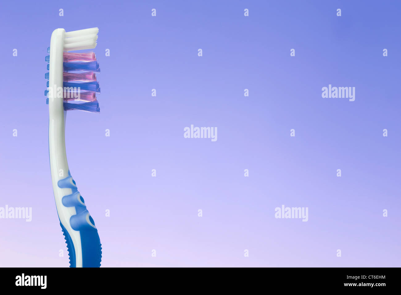 blue and white toothbrush on blue background Stock Photo - Alamy