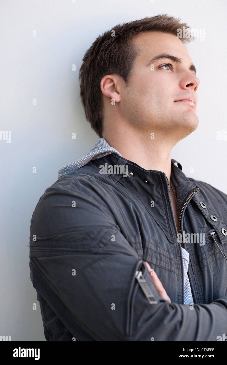 Thoughtful young man isolated on white background Stock Photo - Alamy