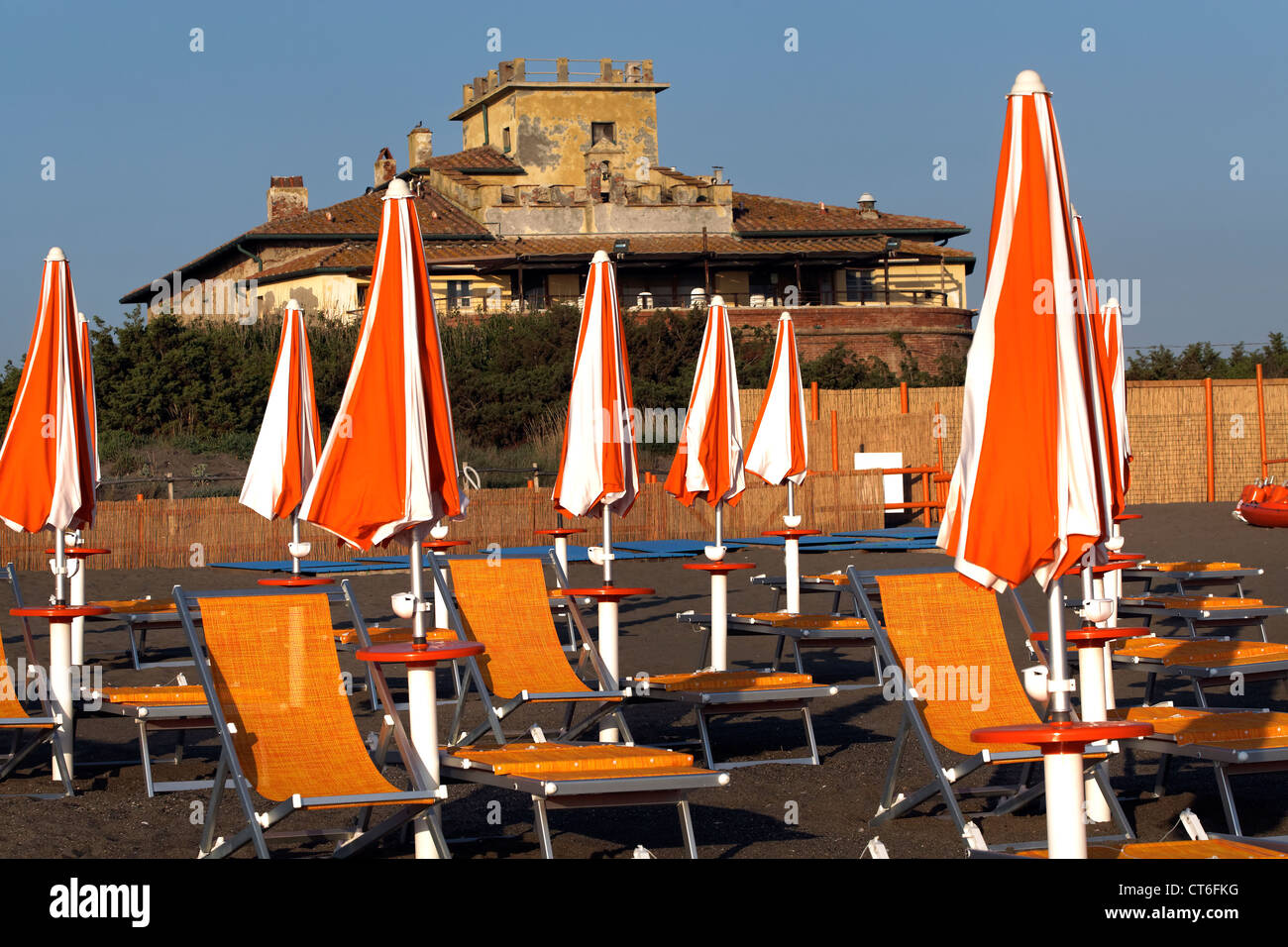 The fortress of Bibbona with closed sun umbrellas and deck chairs on a ...