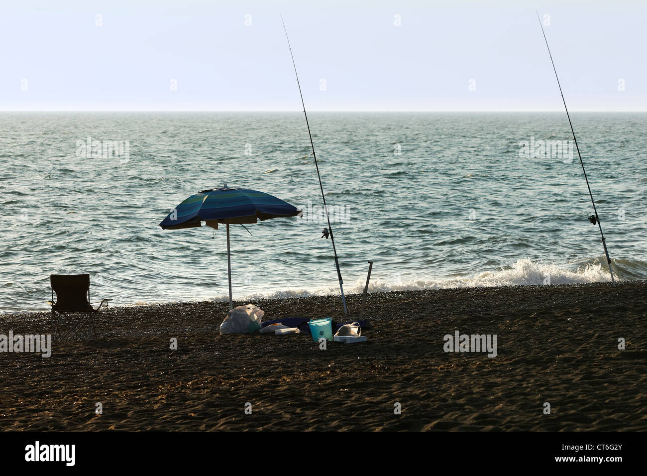 Fishing rods and umbrella on a Italian beach, Bibbona Tuscany Italy ...