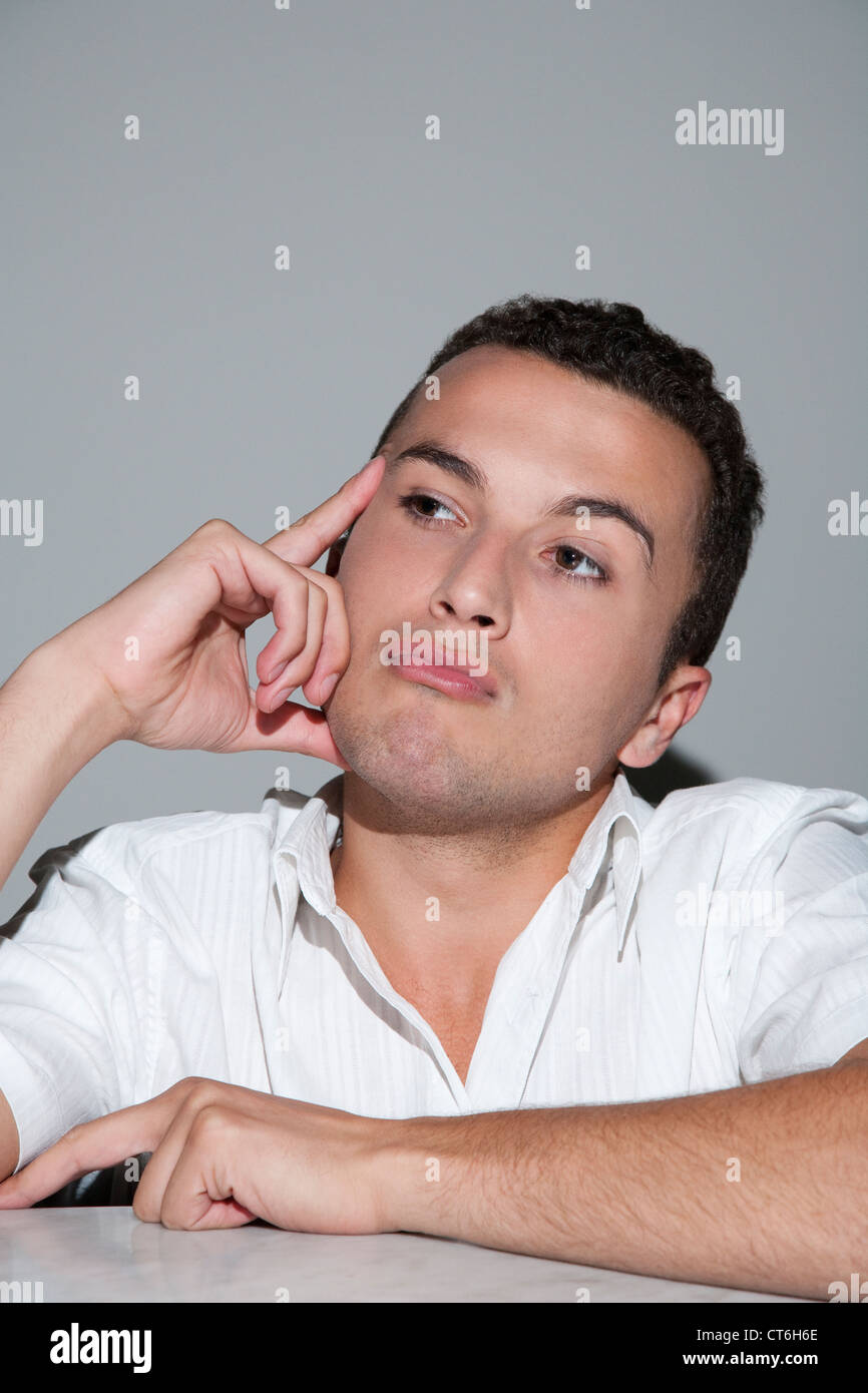 Tired young man contemplating Stock Photo - Alamy