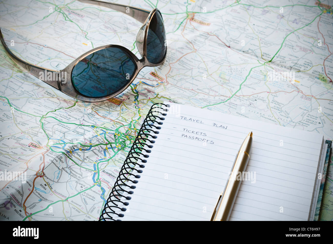 Travel plan concept with notebook, writing, sunglasses, map and ...