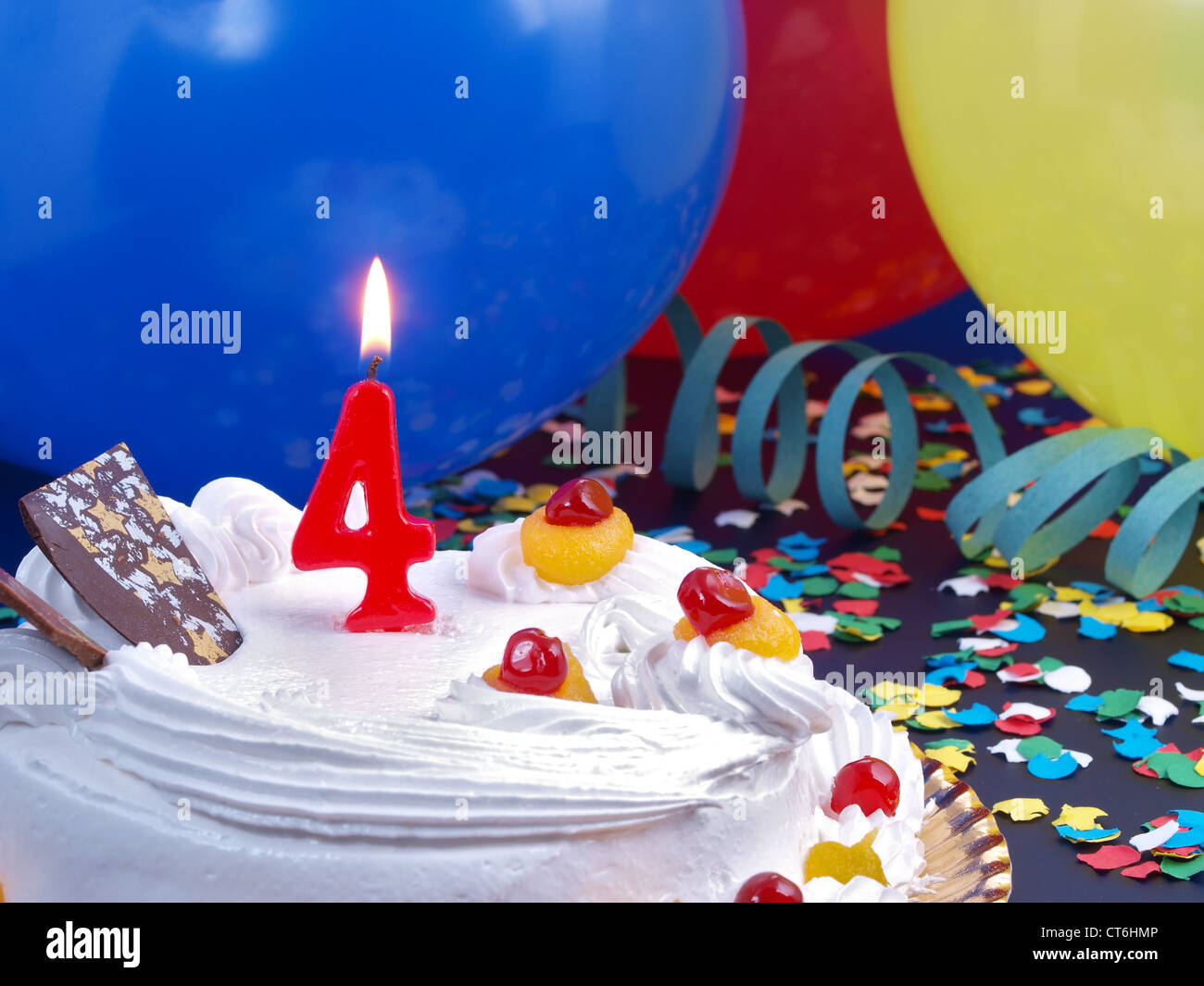 Birthday-anniversary cake with red candle showing Nr. 4 Stock Photo - Alamy