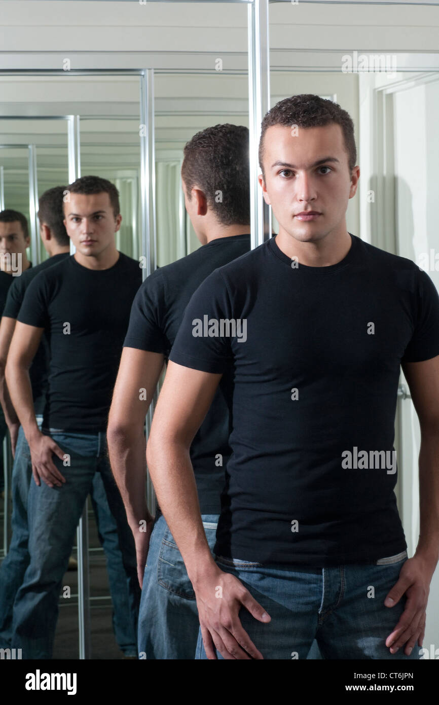 Portrait of a handsome young man standing in front of a mirror Stock ...