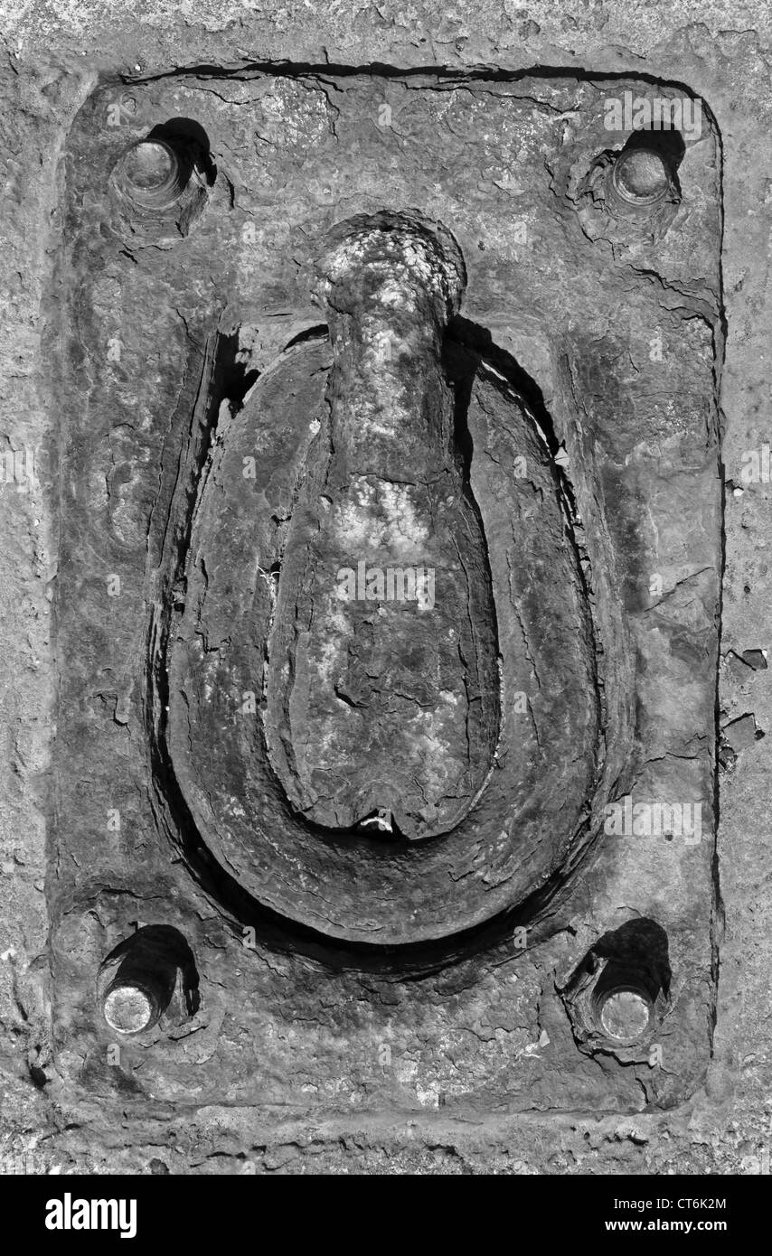 Rusted metal hitching ring set in a concrete pier Stock Photo - Alamy