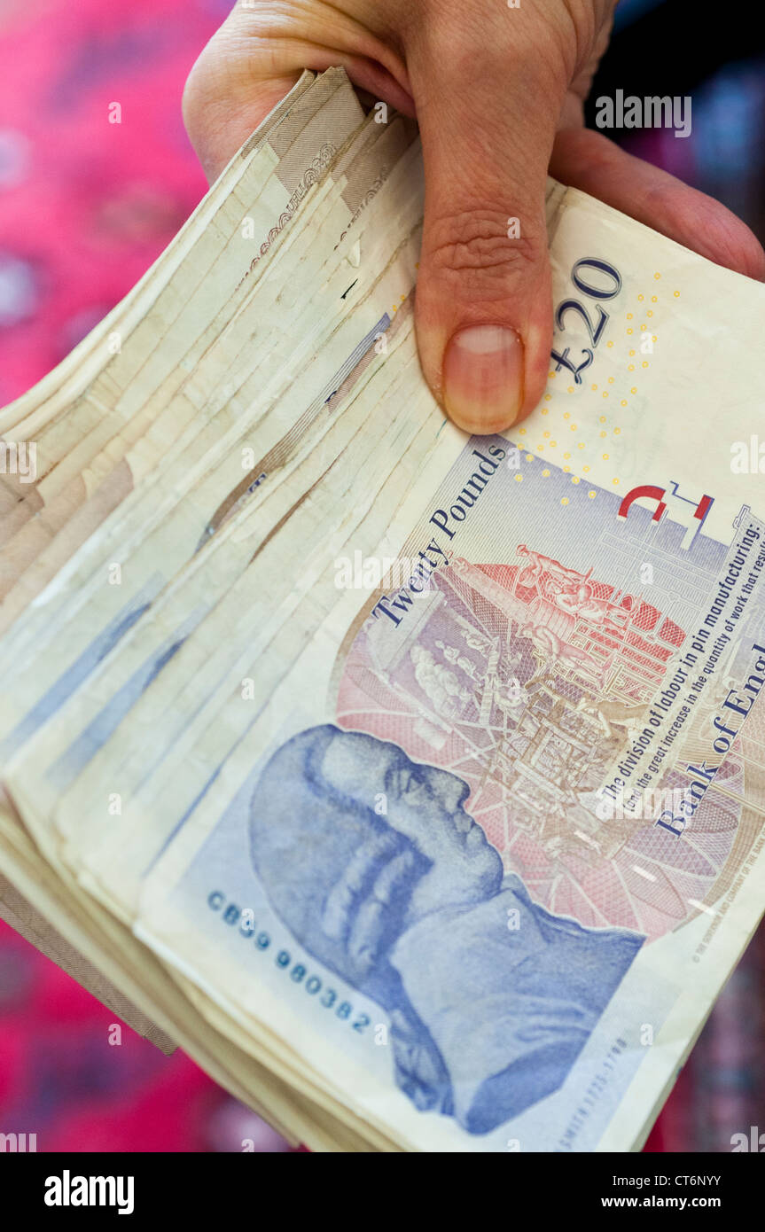 20 pound notes and hand hi-res stock photography and images - Alamy
