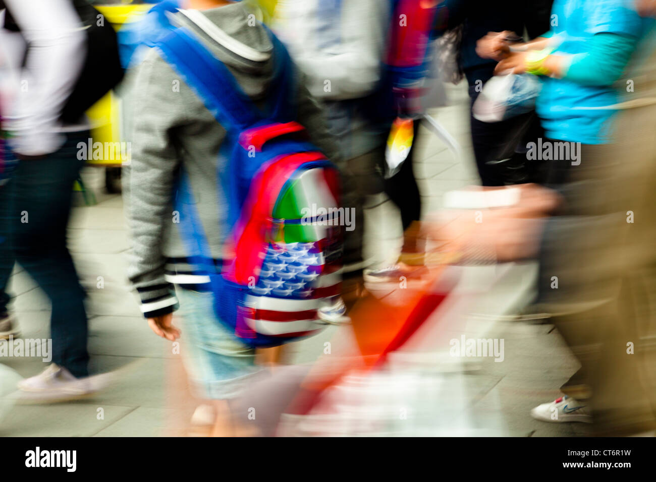 Motion blur of a crowd of people moving on a busy city centre street ...