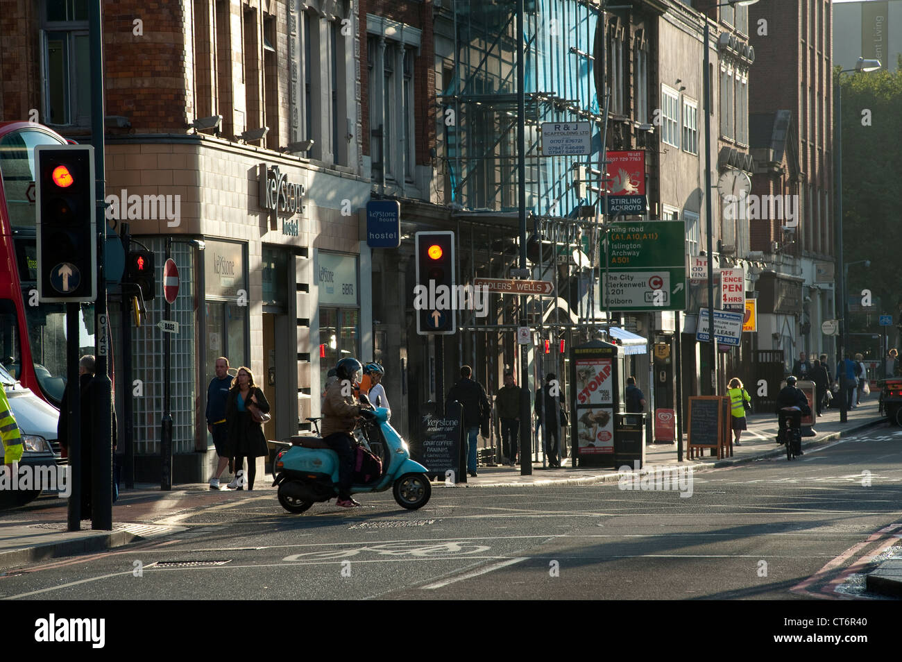 Traffic traveling along a London street early in the morning, England ...