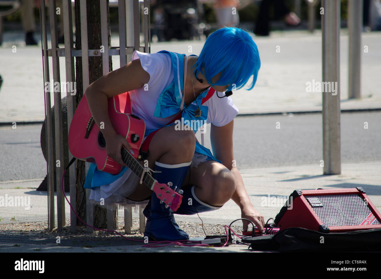 Woman buskin in a town center Stock Photo - Alamy