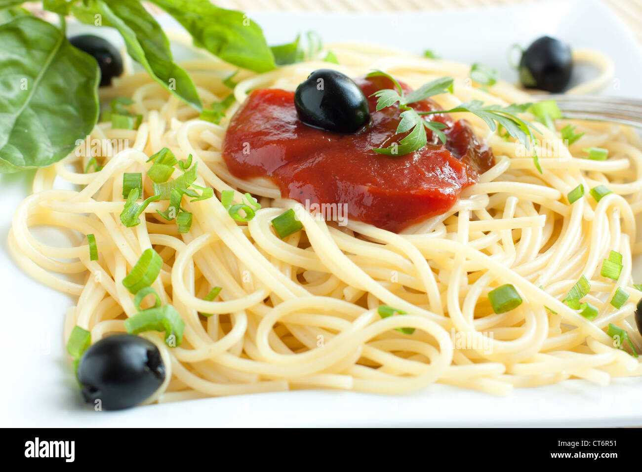 Cooked spaghetti closeup with olives Stock Photo - Alamy