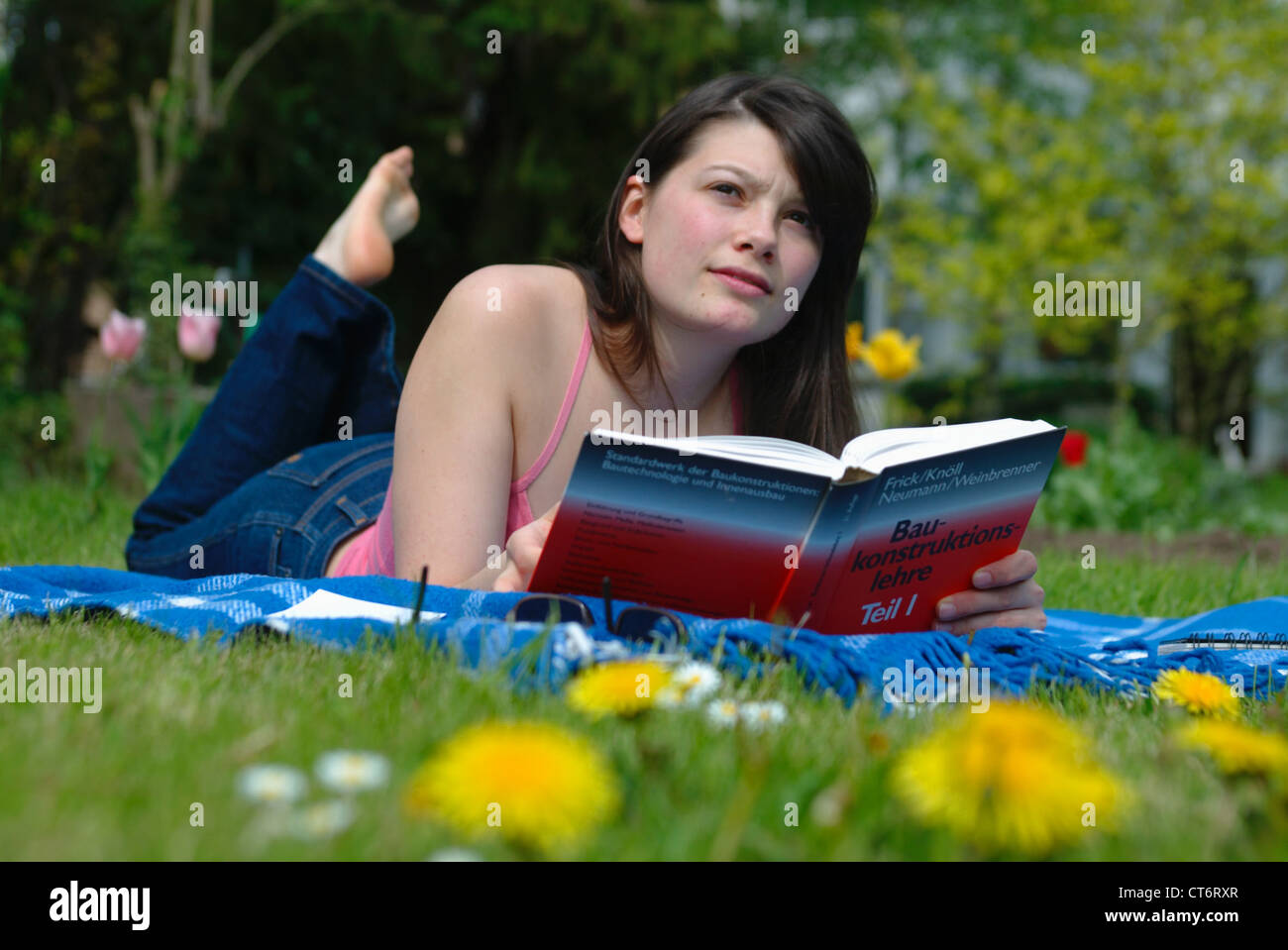 Attractive student reading a textbook Stock Photo - Alamy