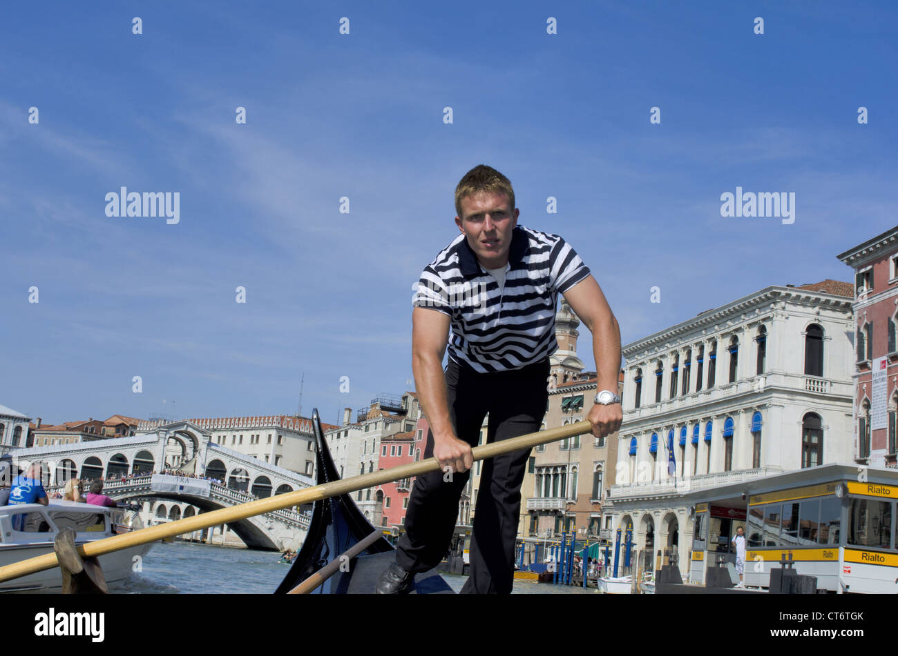 Gondolier on gondola, a traditional, flat-bottomed Venetian rowing boat ...