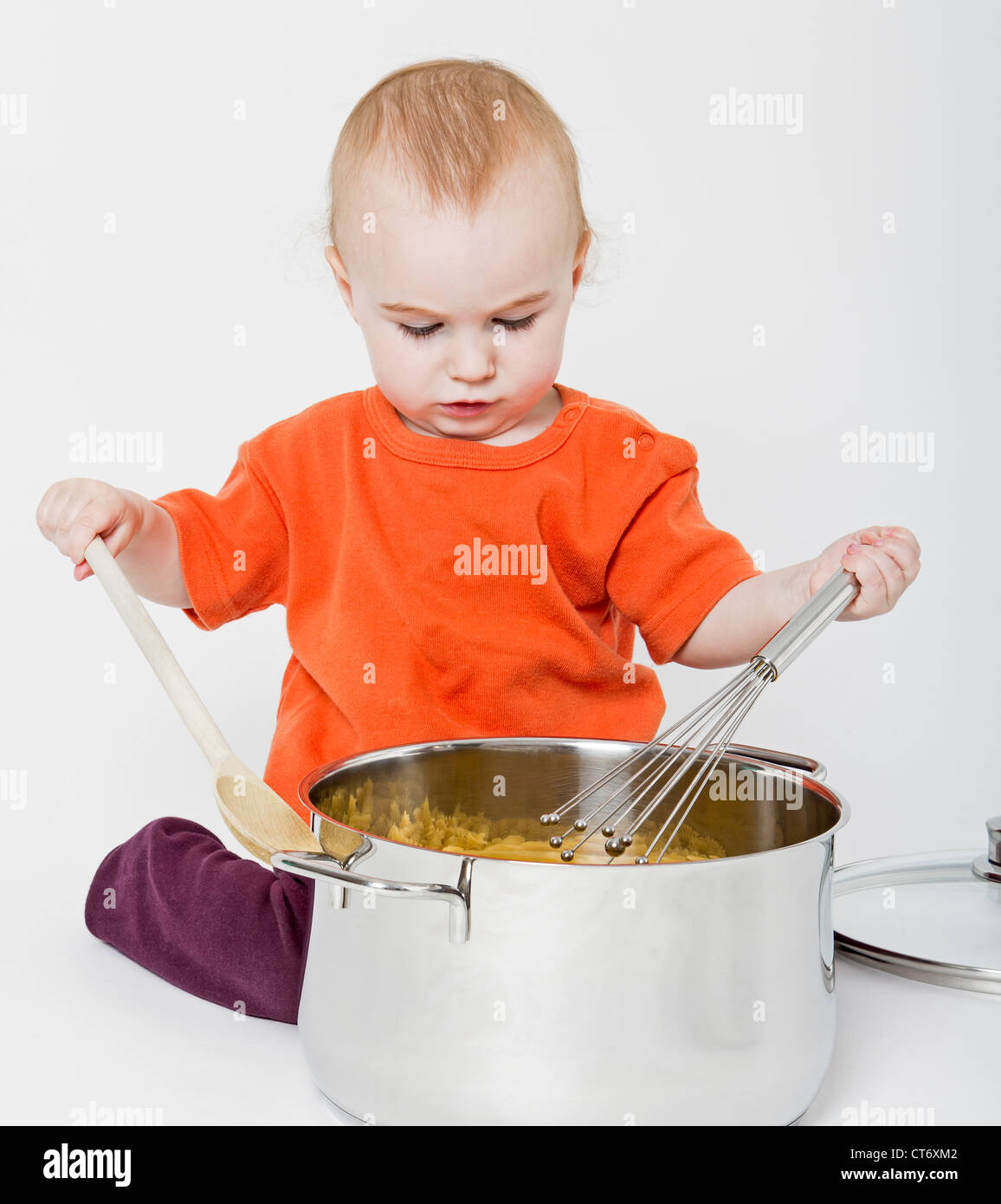 baby with big cooking pot on neutral grey background Stock Photo - Alamy