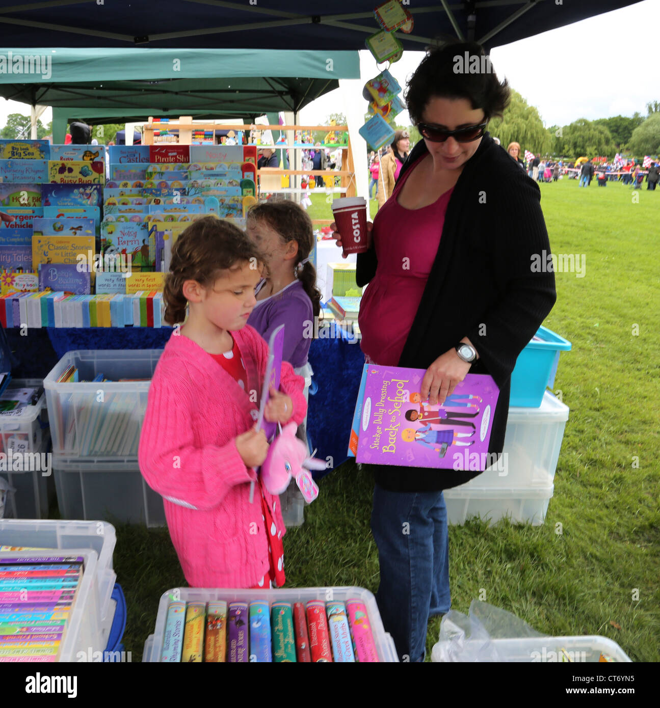 Mother And Children Choosing Books From Usborne Book Stand At Cheam ...