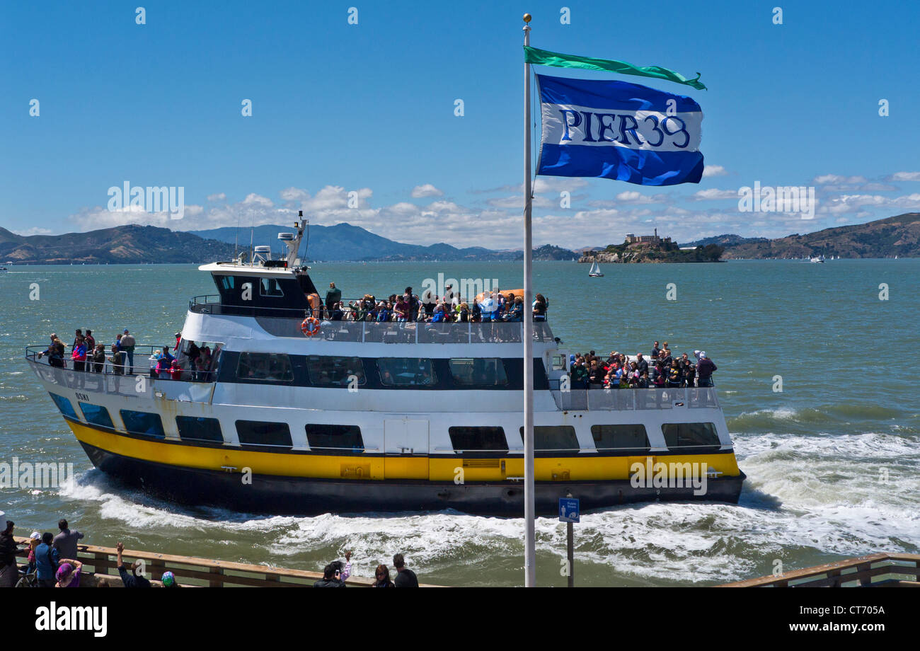 ALCATRAZ Pier 39 flag with Alcatraz prison island behind, tour boat ...