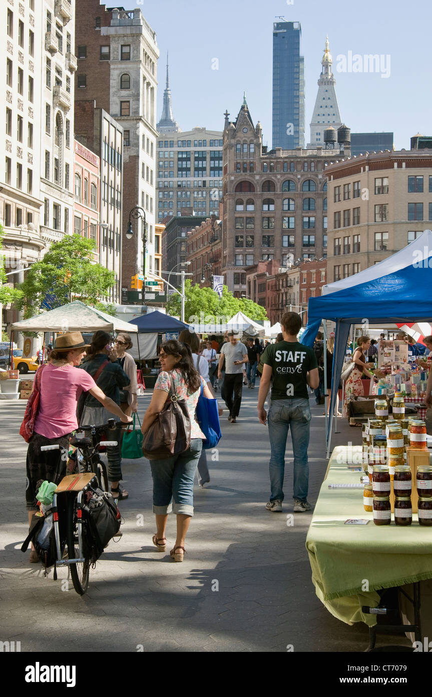 A summer morning at the Union Square farmers market in NYC, with the ...