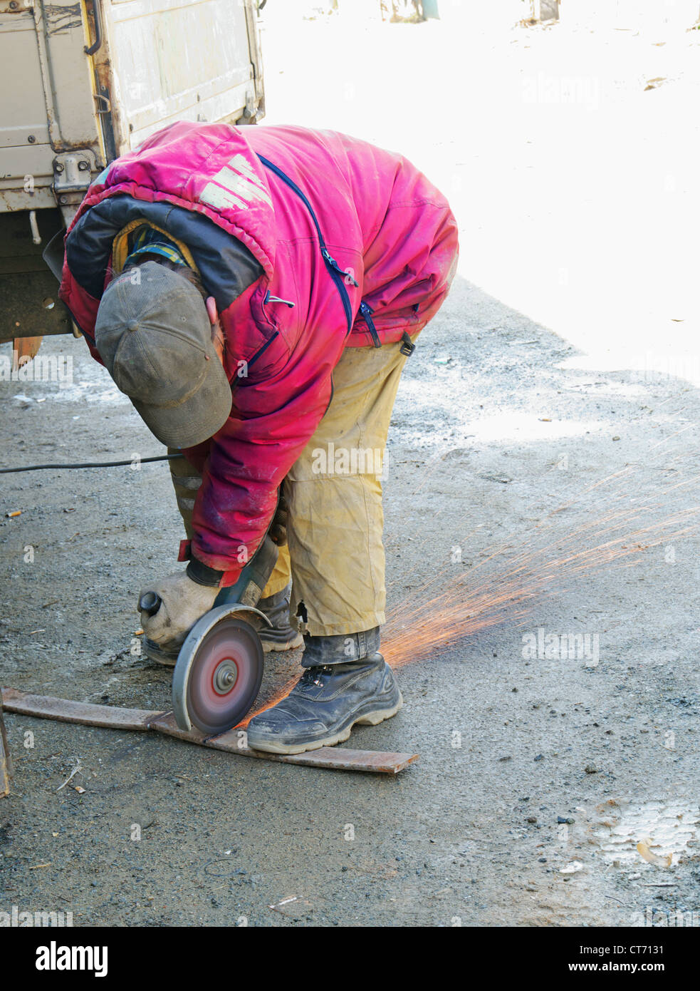 Worker cutting metal with many sharp sparks Stock Photo - Alamy
