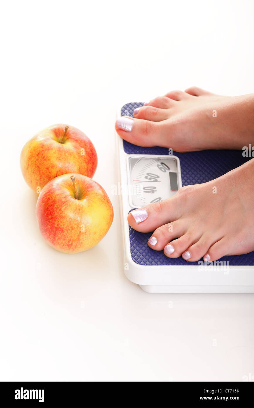 Woman feet and blue weight scale isolated on white background Stock ...