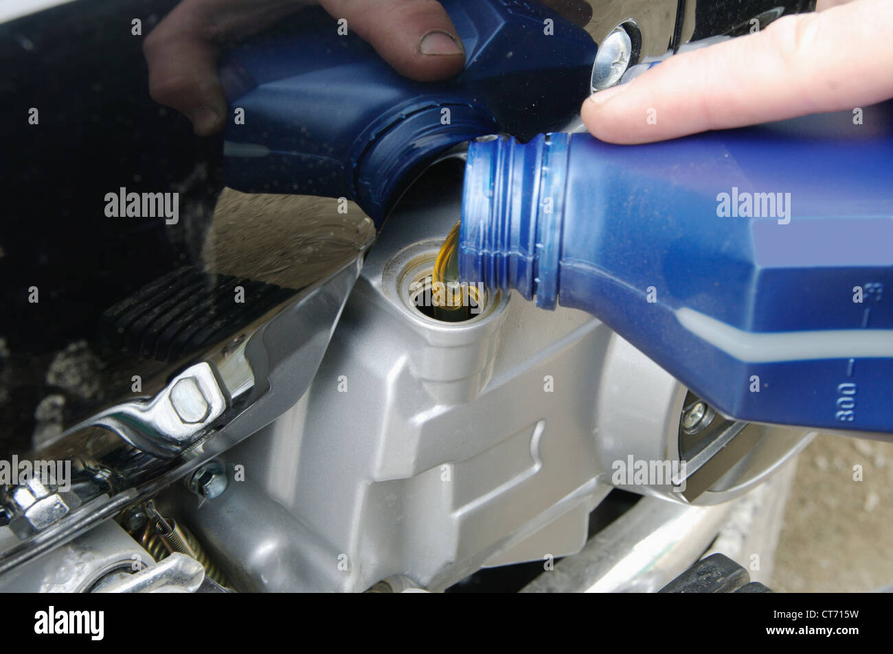 Fill oil to the engine after driving motorcycle Stock Photo - Alamy