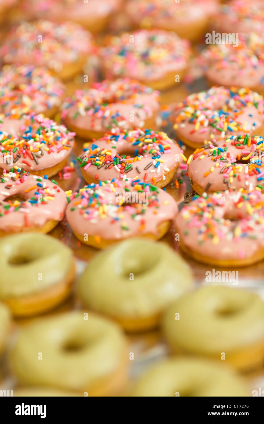 Pink glazed doughnuts with colorful sprinkles at Tandmen Doughnuts, a ...