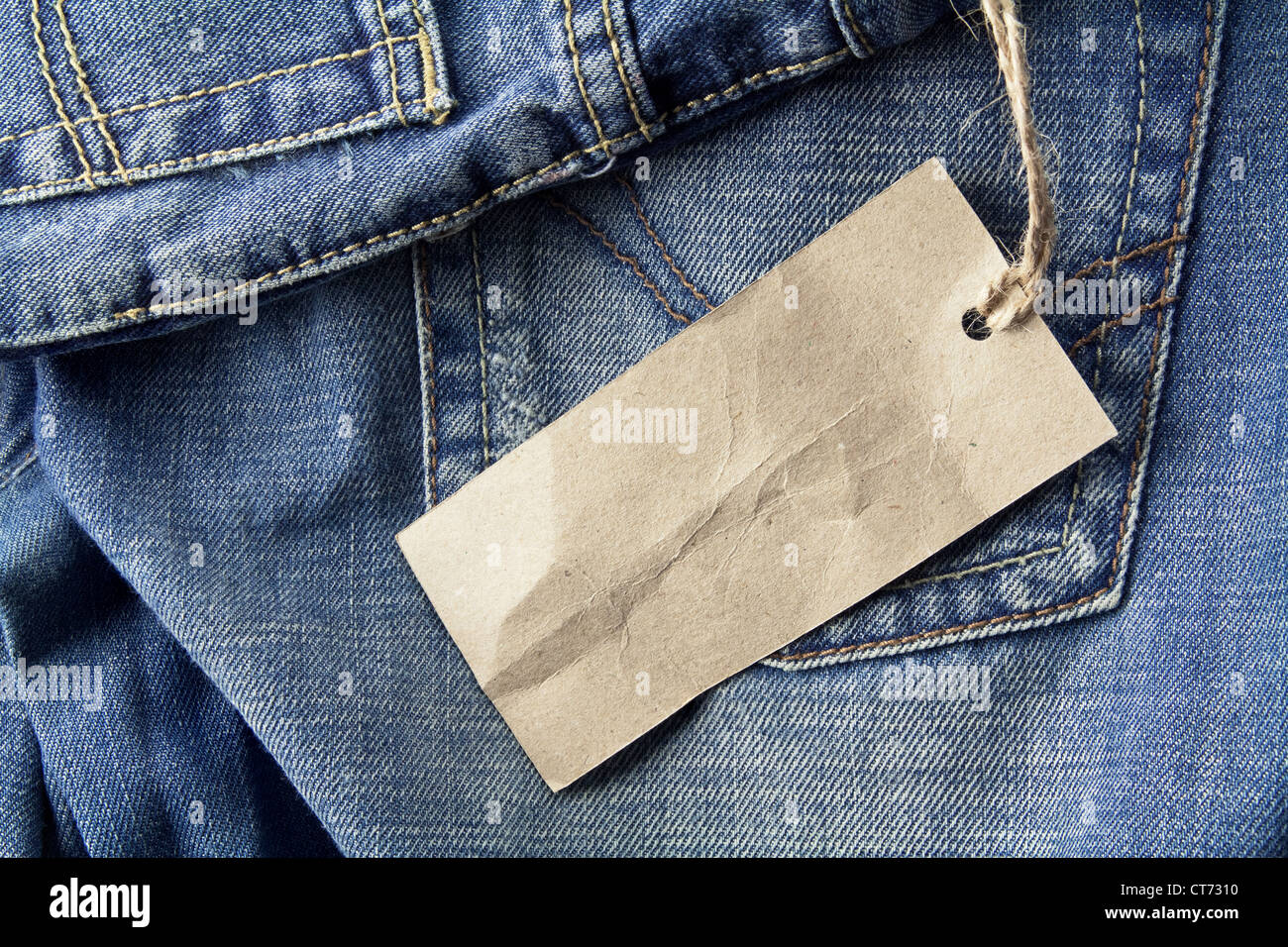 Jeans trousers with blank paper label Stock Photo - Alamy