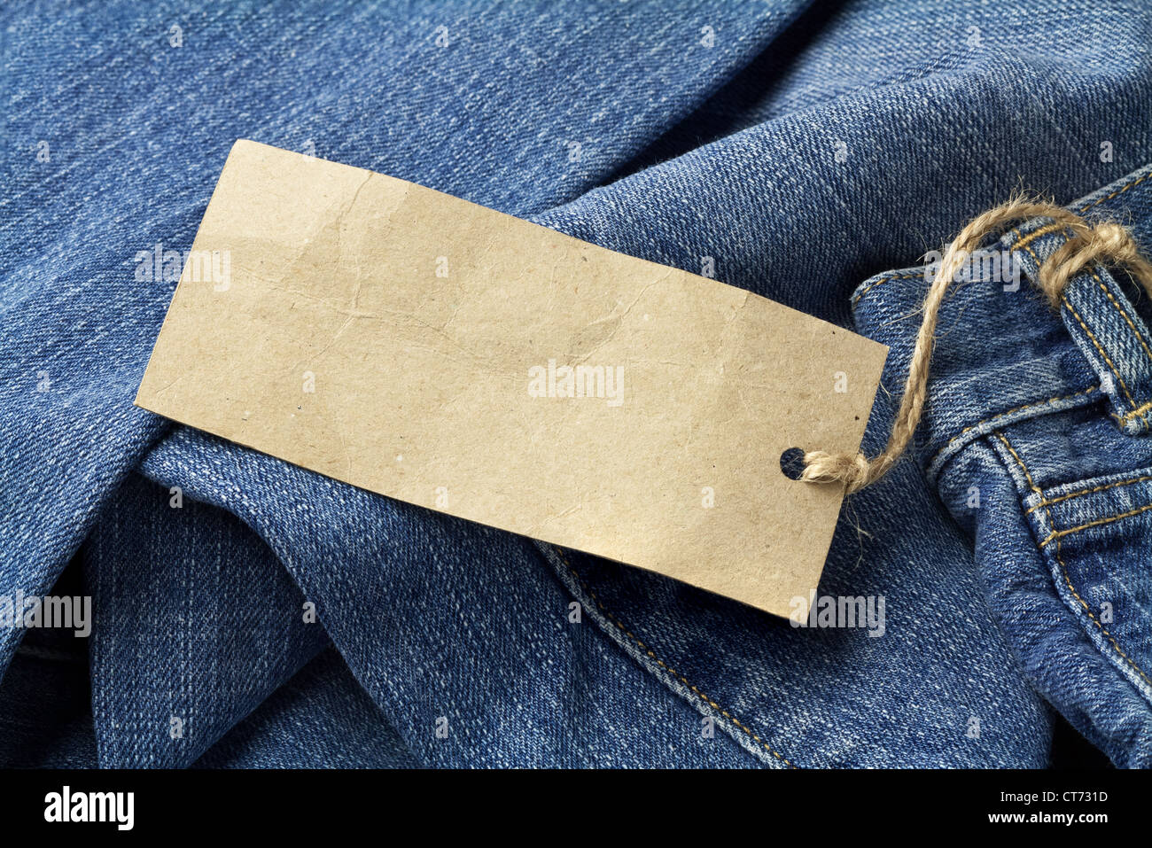 Jeans trousers with blank paper label Stock Photo - Alamy