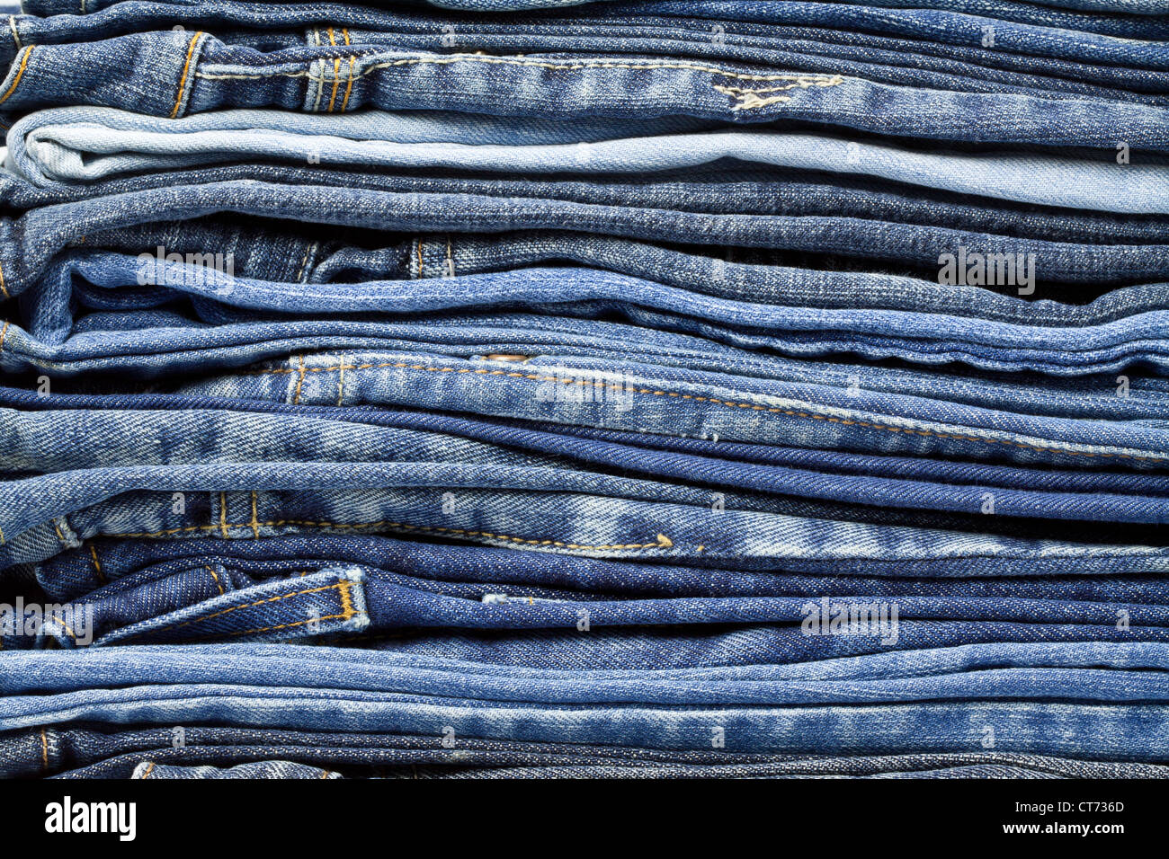 Jeans trousers stack closeup Stock Photo - Alamy
