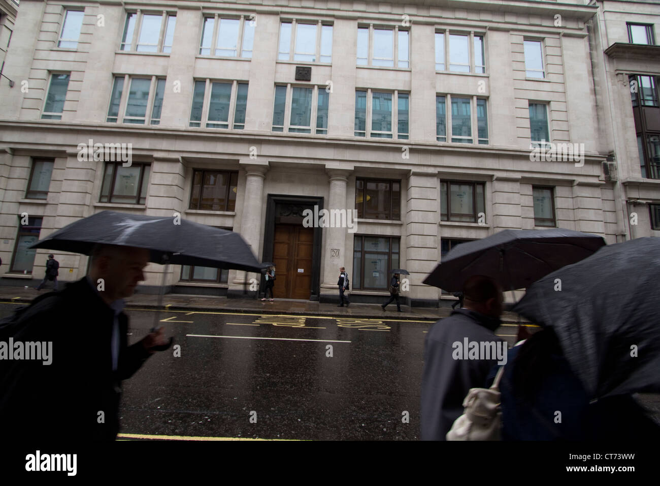 Commuters walk past the offices of the Prudential Regulation Authority ...