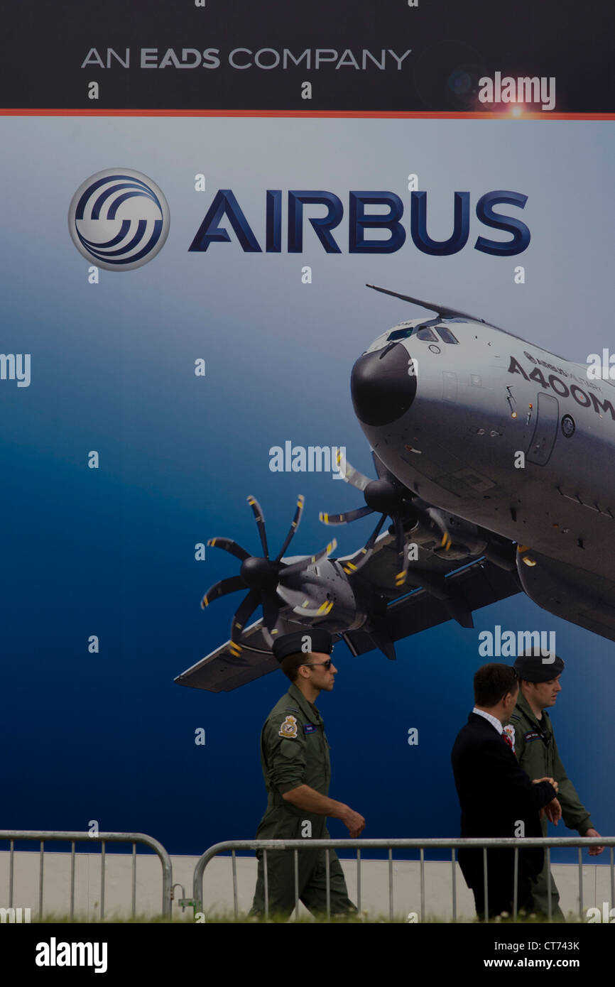 Delegates walk past a billboard of military A400M transporter outside ...