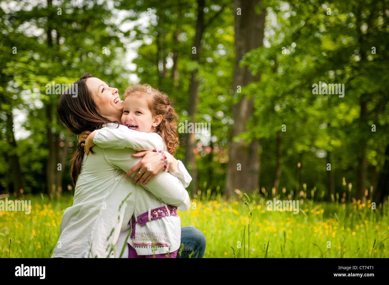 Small girl enjoying life with her mother outdoor in nature Stock Photo ...